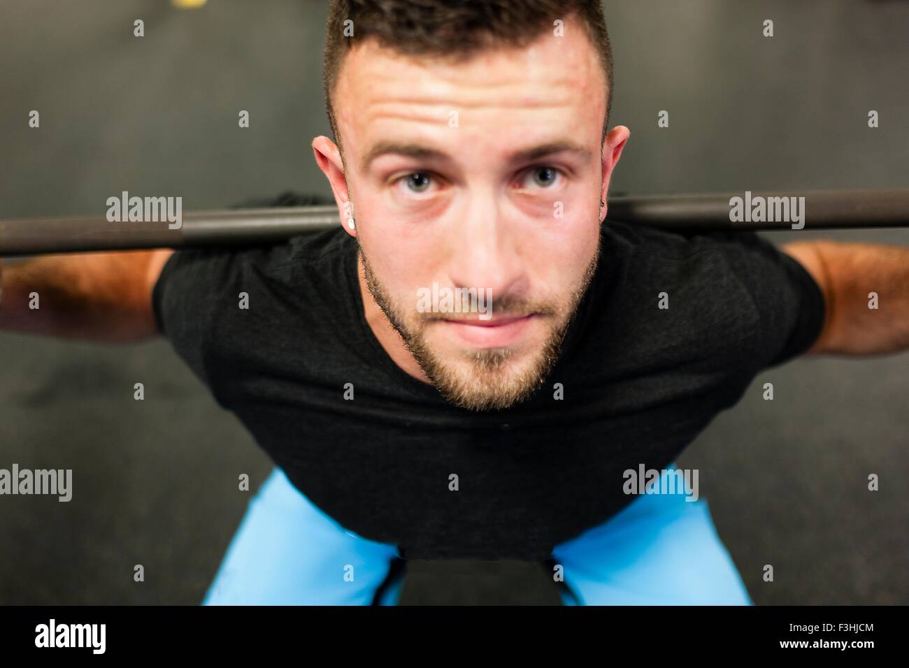Young man, lifting weights, close-up Stock Photo - Alamy