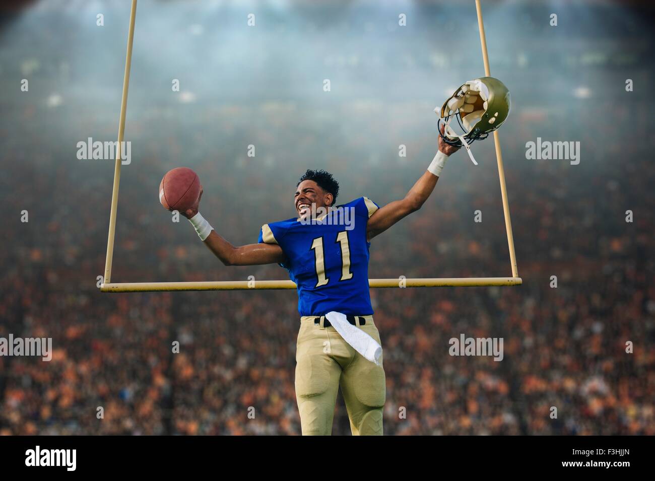 Teenage American football player celebrating victory in soccer stadium ...