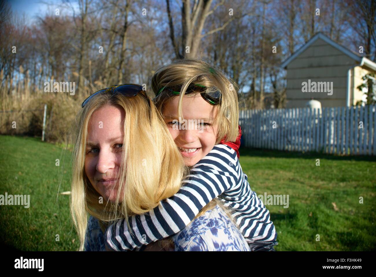 Mother giving her son piggyback hi-res stock photography and images - Alamy