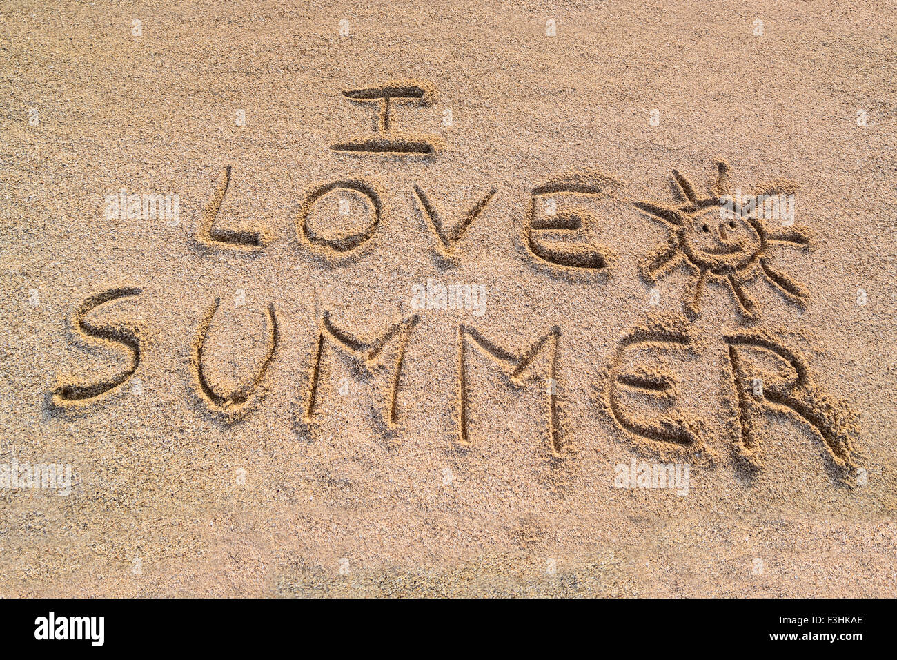 In the picture the writing on the sand "I love summer Stock Photo - Alamy