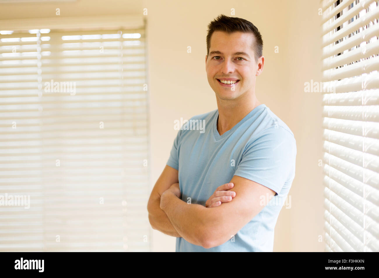handsome young man standing in empty house Stock Photo - Alamy