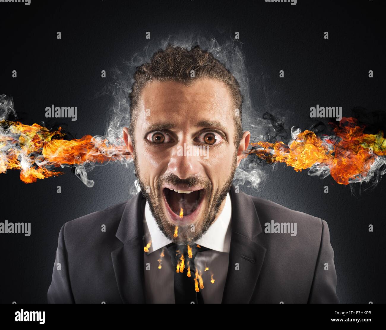 Stressed man spits fire Stock Photo - Alamy