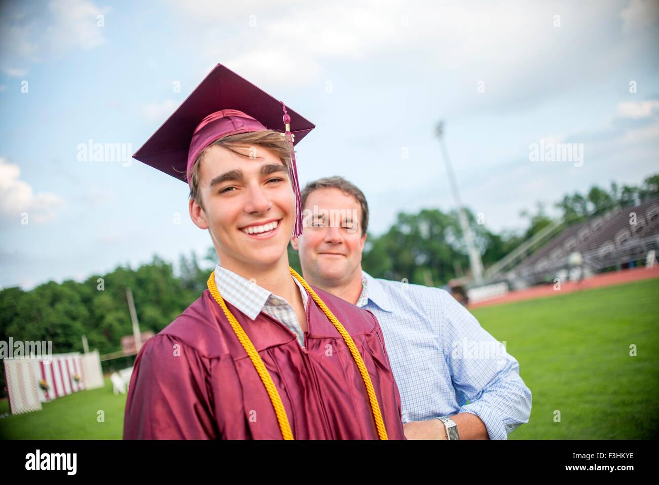 Young man standing with father at graduation ceremony Stock Photo - Alamy