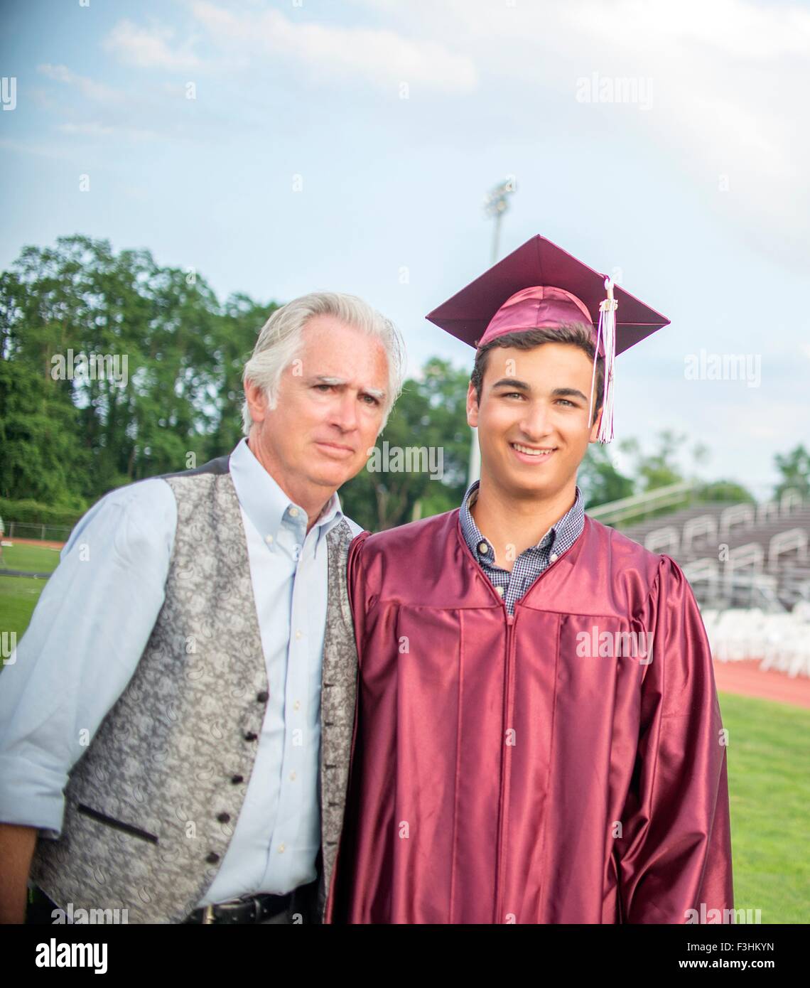 Young man standing with father at graduation ceremony Stock Photo - Alamy