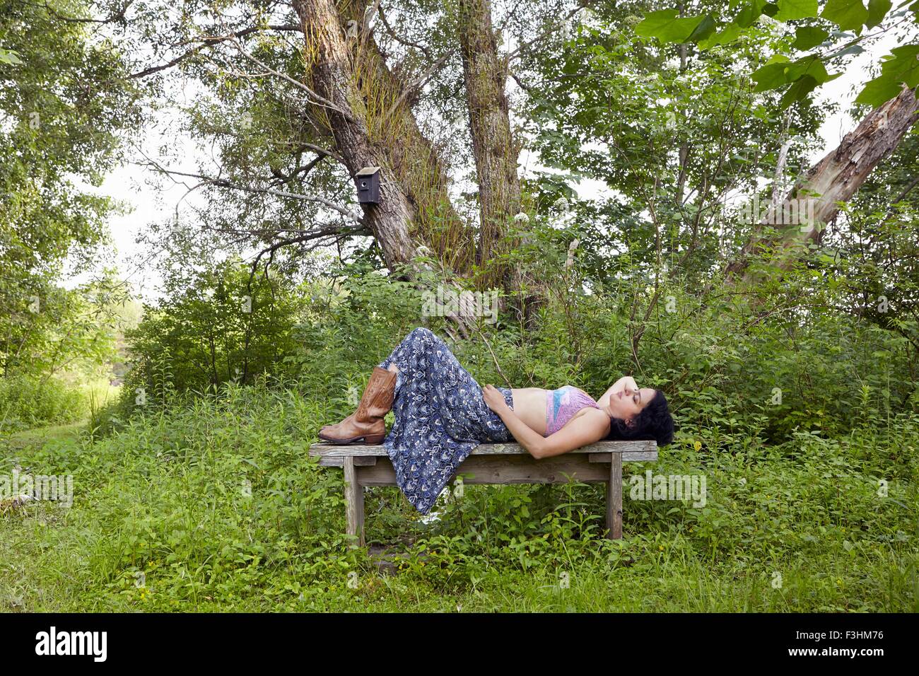 Female lying down on bench hi-res stock photography and images - Alamy