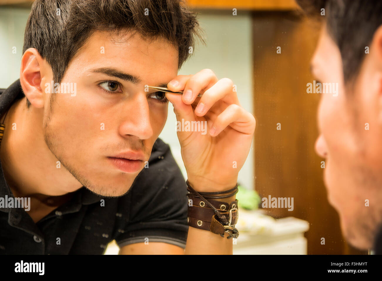 Close Up of Attractive Young Man with Dark Hair Grooming Himself ...