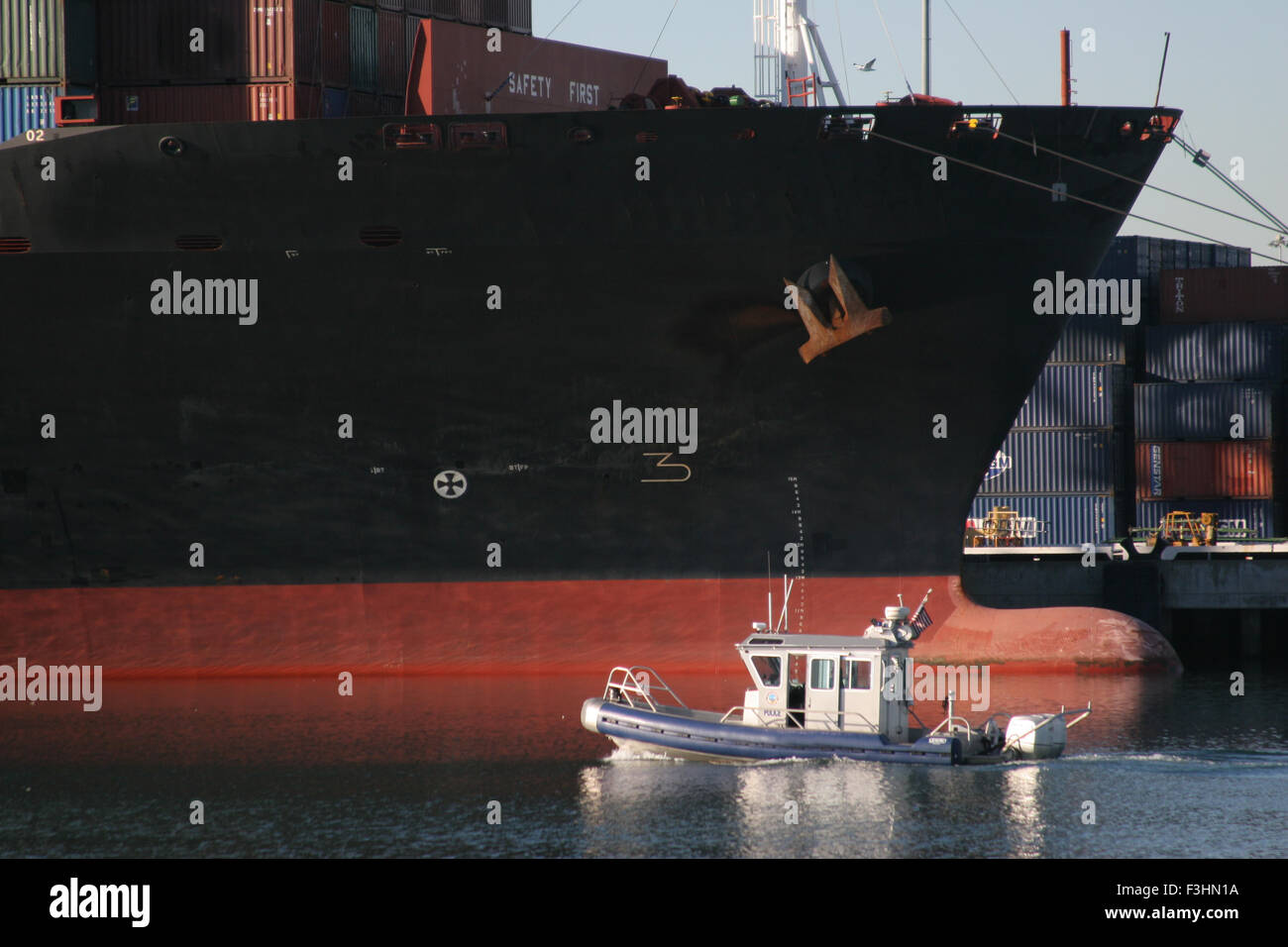 homeland security boat and freighter Stock Photo - Alamy