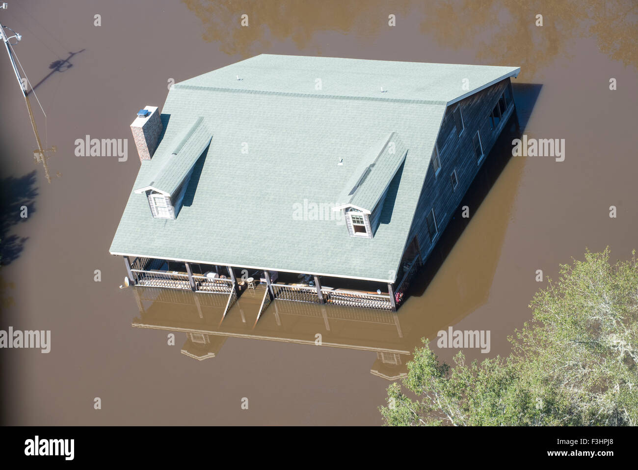 Aerial view of floodwaters submerging a home after record breaking ...
