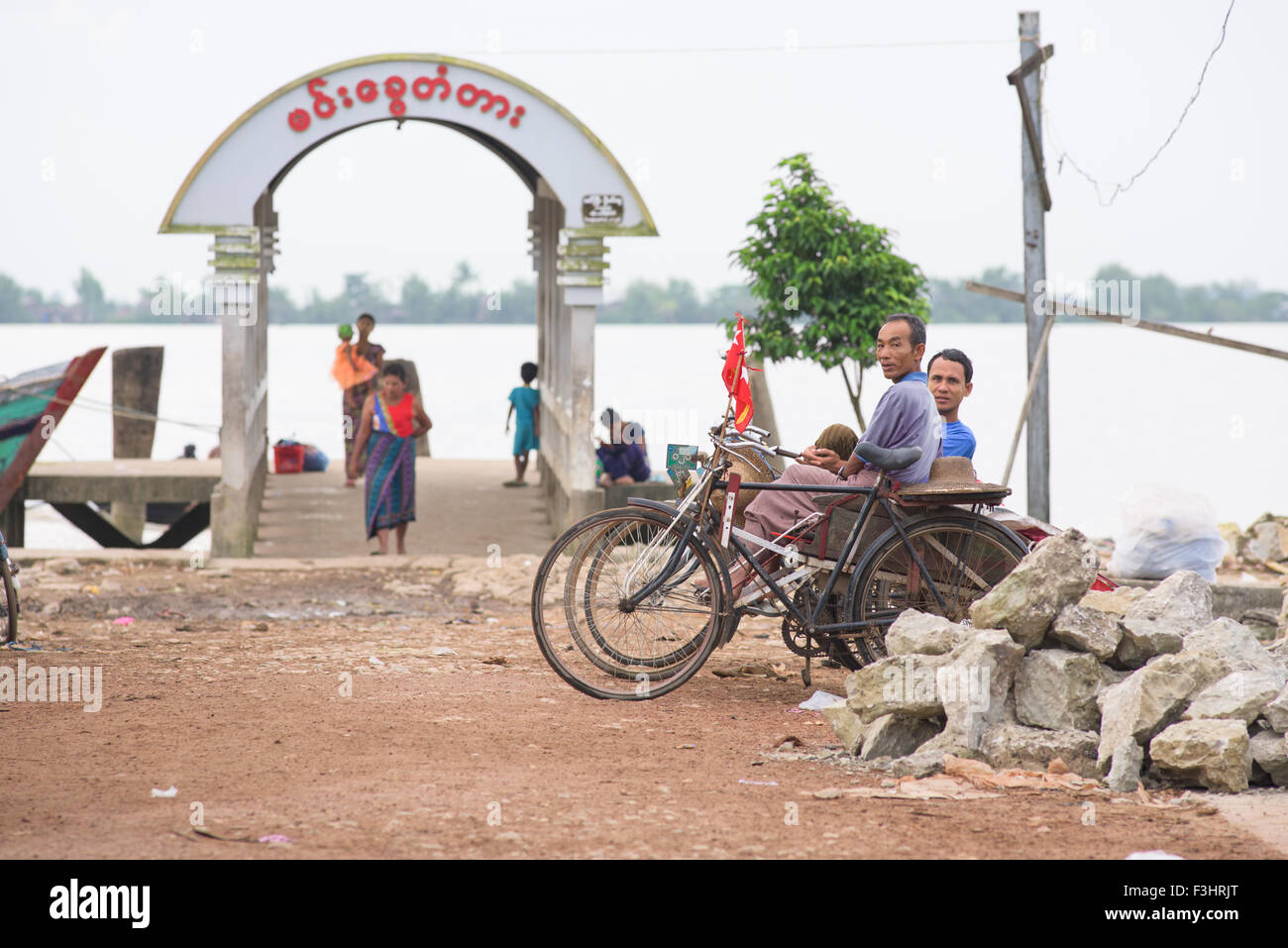 Cyclo drivers waiting for passengers at a pier by the Ywe River in ...