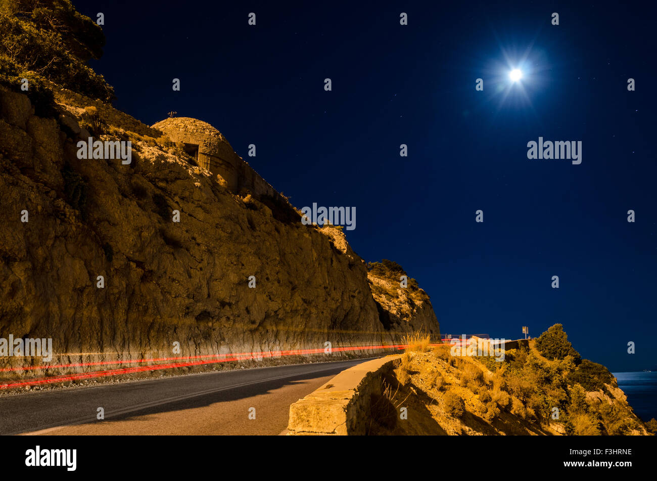 Night road under the full moon in Corinth's Greece Stock Photo - Alamy
