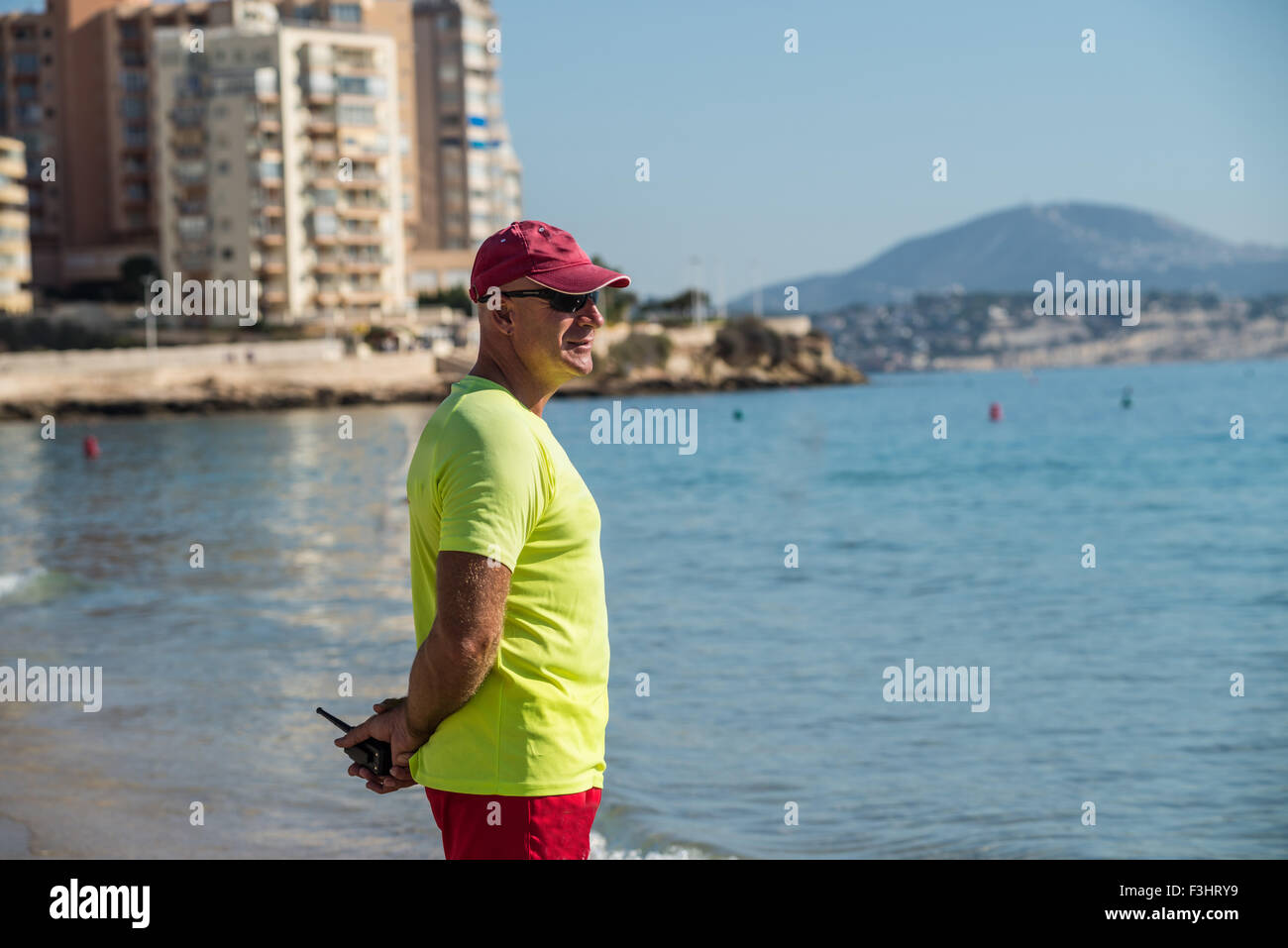 Lifeguard standing on the shore of a beach resort Stock Photo - Alamy