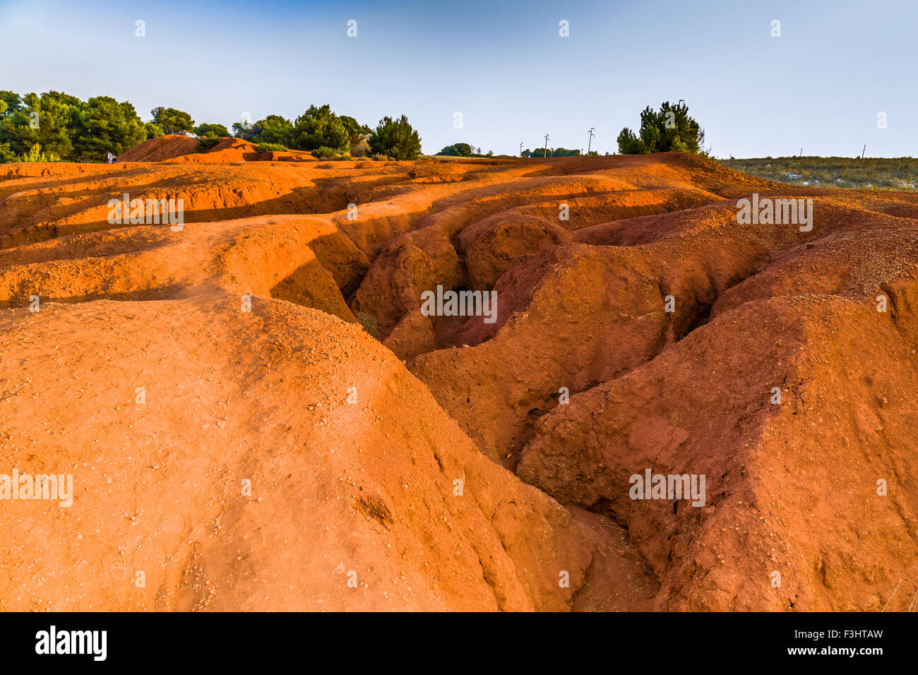 red soils around the freshwater lake formed in a former quarry for the ...