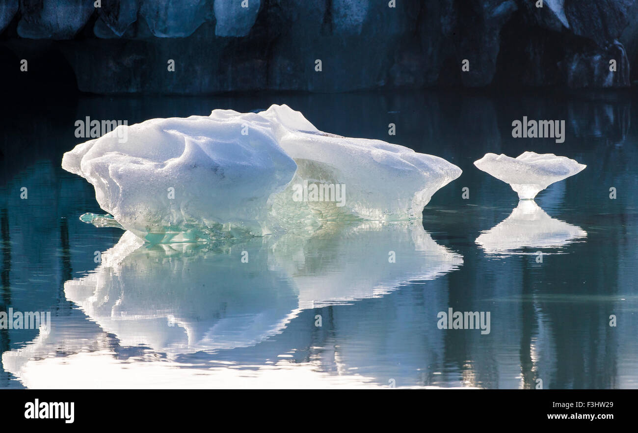 Glacial Ice floating on a still freshwater surface with very clear ...