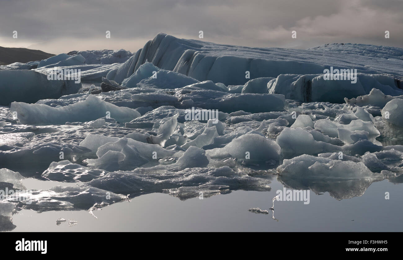 Glacial Ice floating on a still freshwater surface with very clear ...