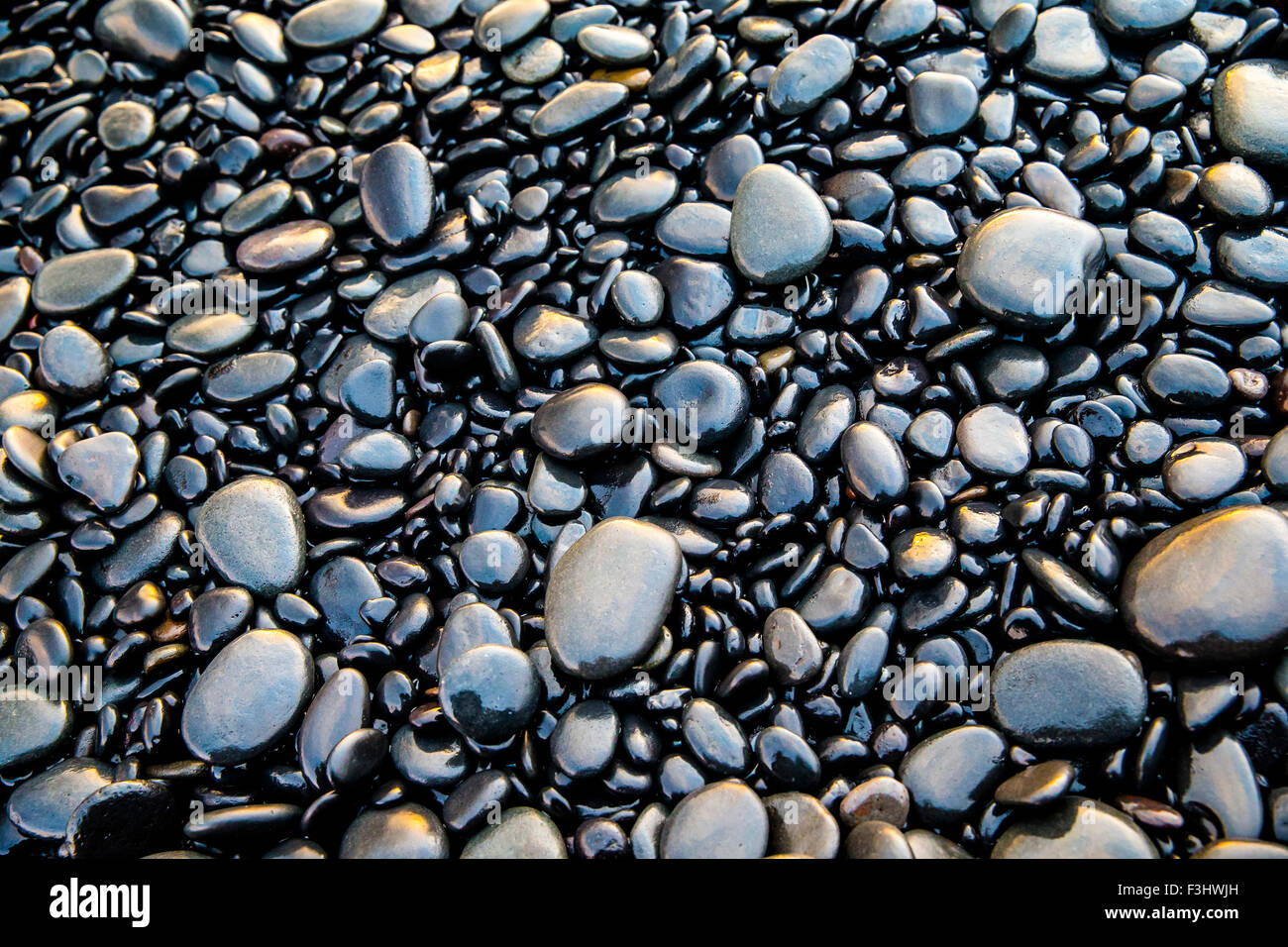 Shiny pebbles on beach hi-res stock photography and images - Alamy
