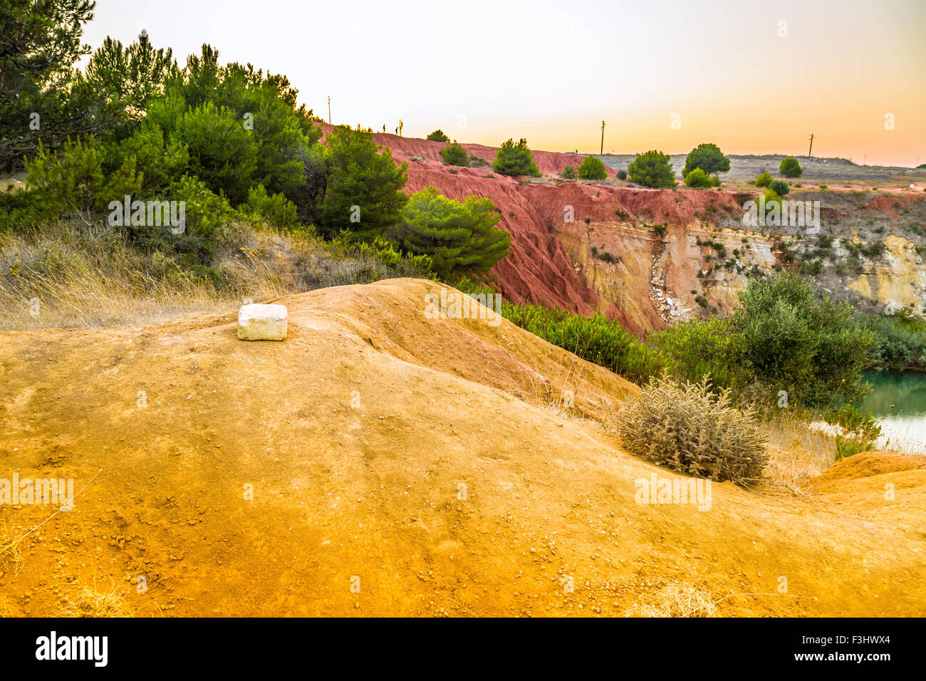 red soils around the freshwater lake formed in a former quarry for the ...