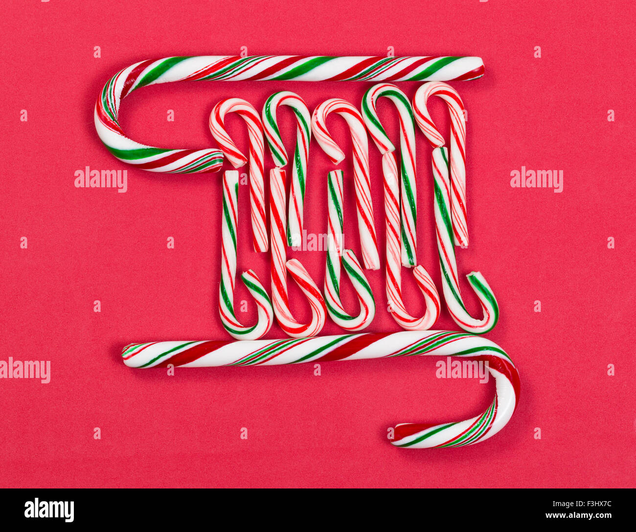Pattern of peppermint candy canes on red background Stock Photo - Alamy