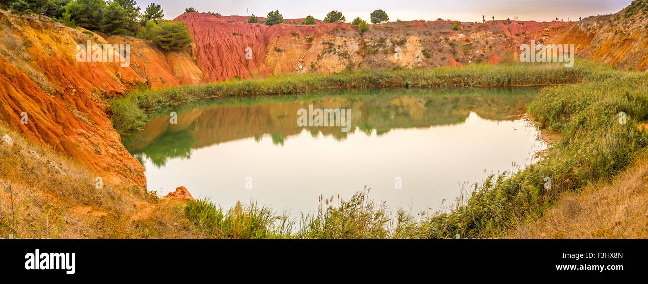 red soils around the freshwater lake formed in a former quarry for the ...