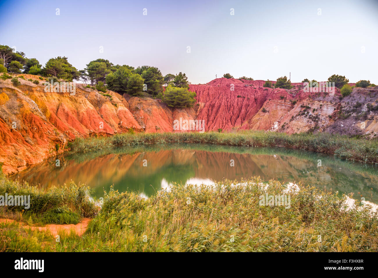 red soils around the freshwater lake formed in a former quarry for the ...