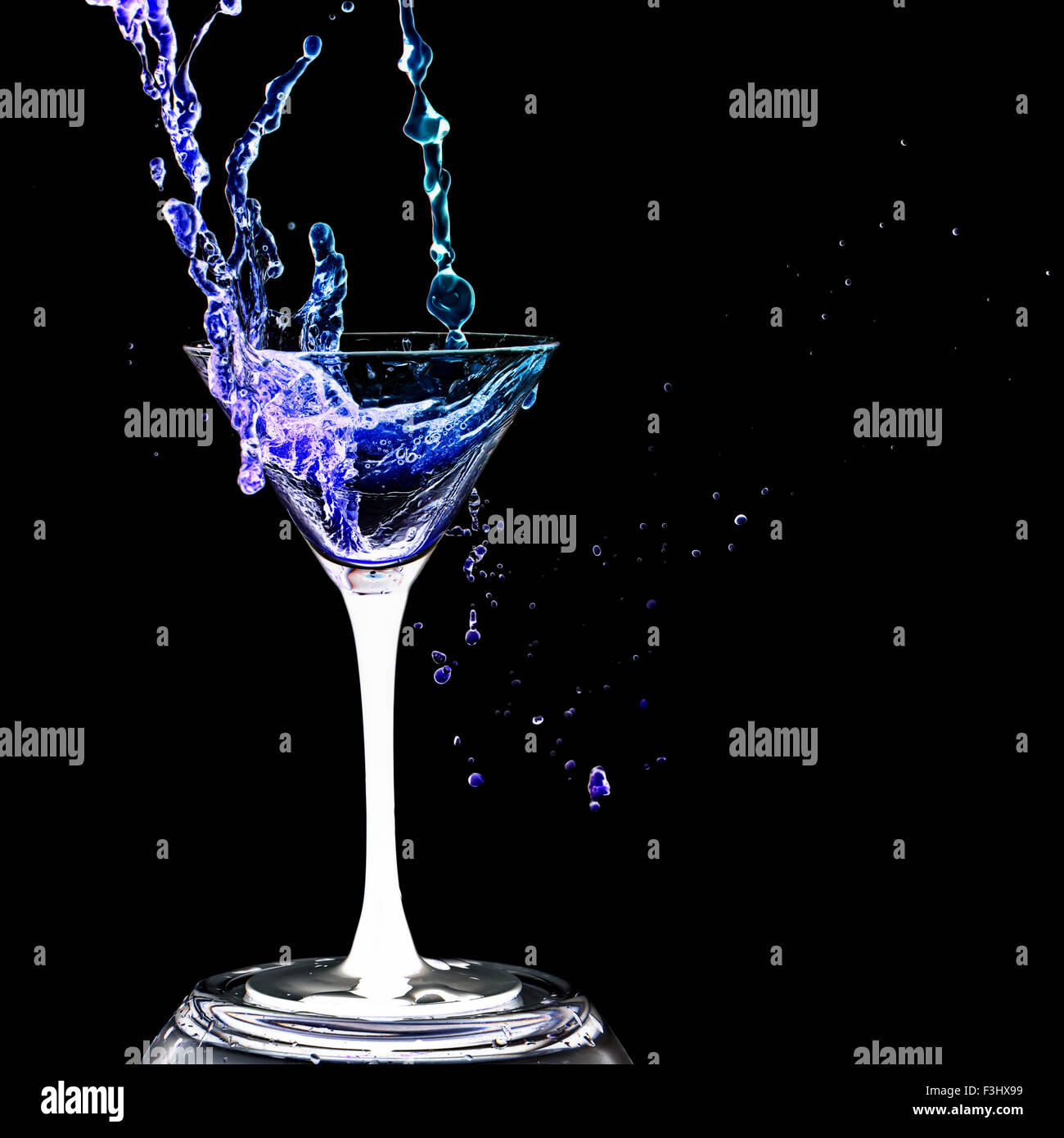 Abstract art. Cocktail glass with splashes of liquid isolated on a ...