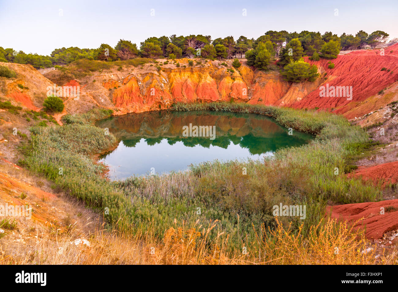 red soils around the freshwater lake formed in a former quarry for the ...