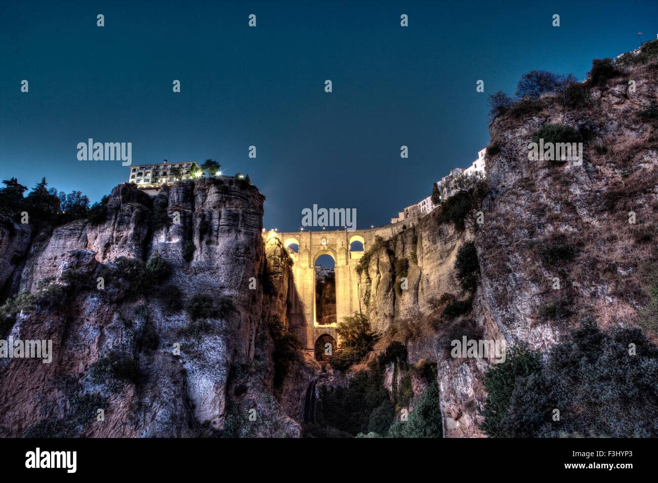 illuminated Puente Nuevo Bridge from outskirts of Ronda at sunset ...