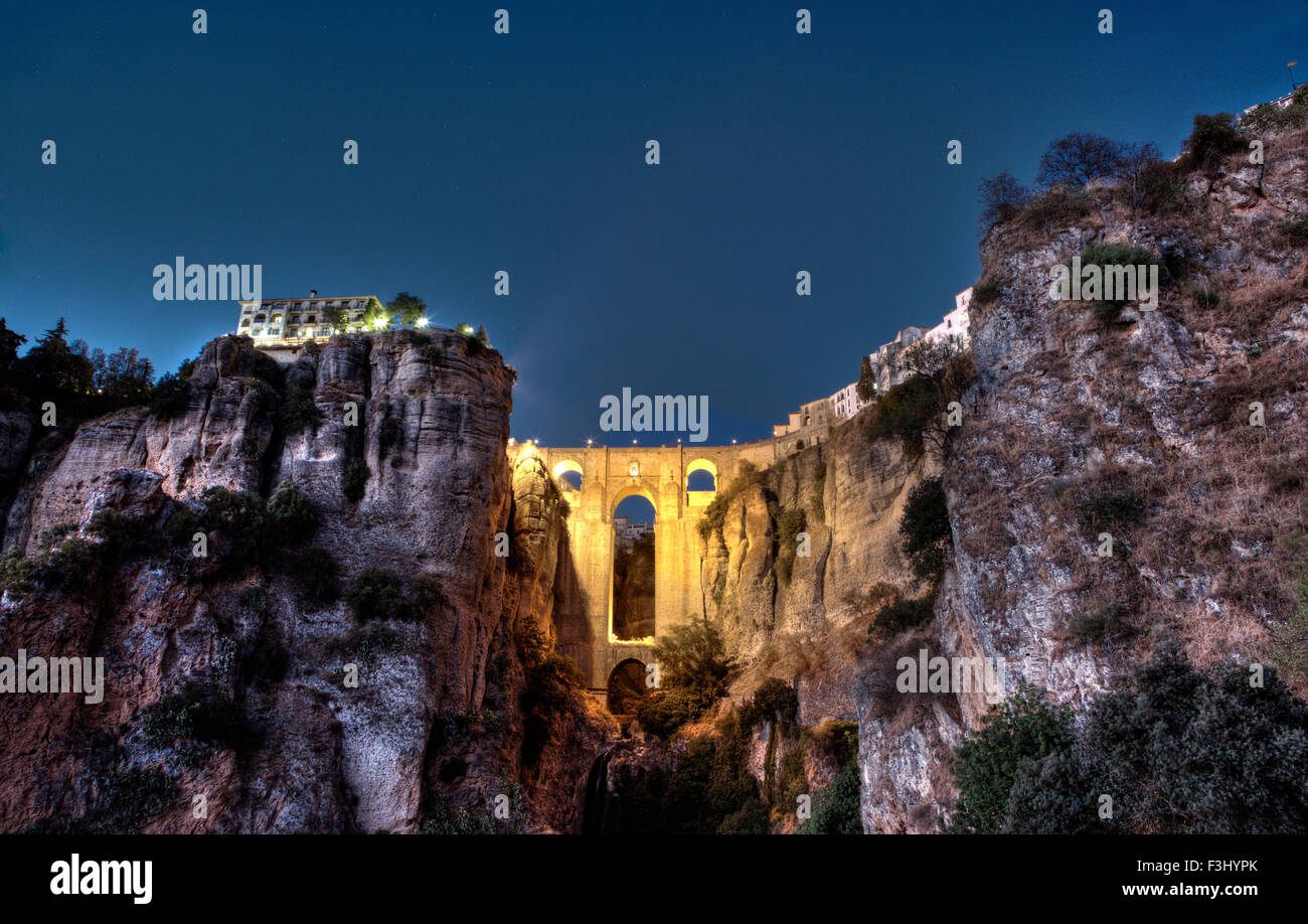 illuminated Puente Nuevo Bridge from outskirts of Ronda at sunset ...