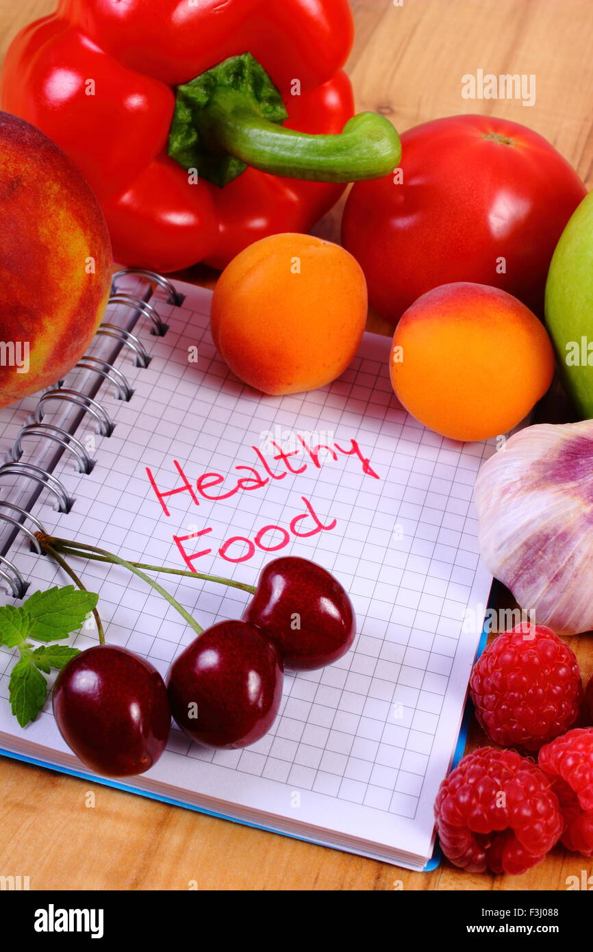 Fresh fruits and vegetables with notebook for writing notes, concept of ...