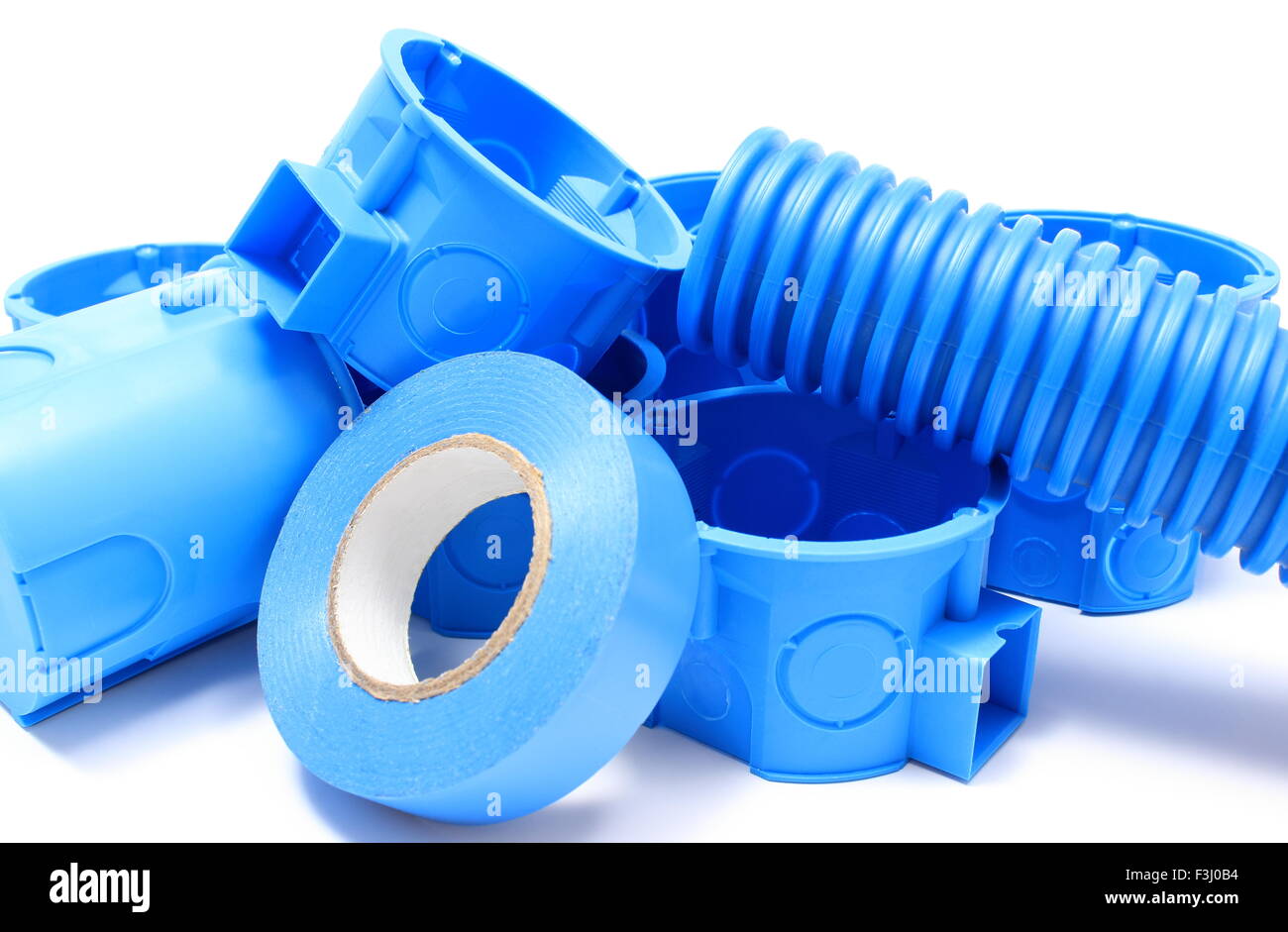 Heap of blue electrical boxes and components for use in electrical ...