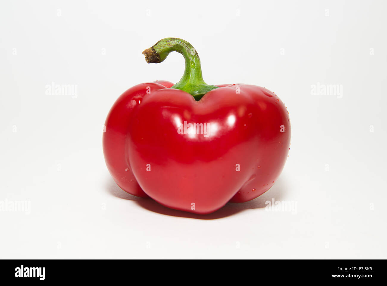One red pepper on a white background Stock Photo - Alamy