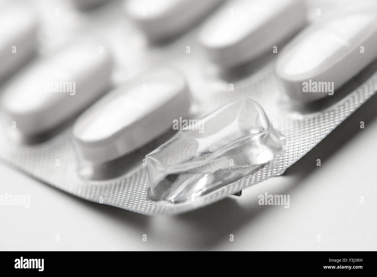 Forefront of a white medicine pills in blister pack Stock Photo - Alamy