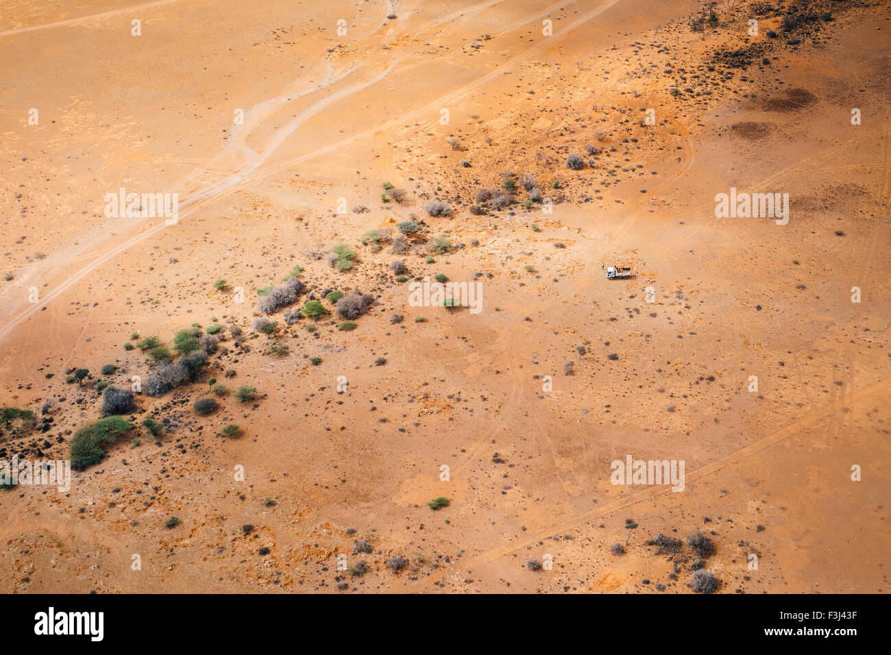Aerial image from Somalia. A man standing next to his truck Stock Photo ...