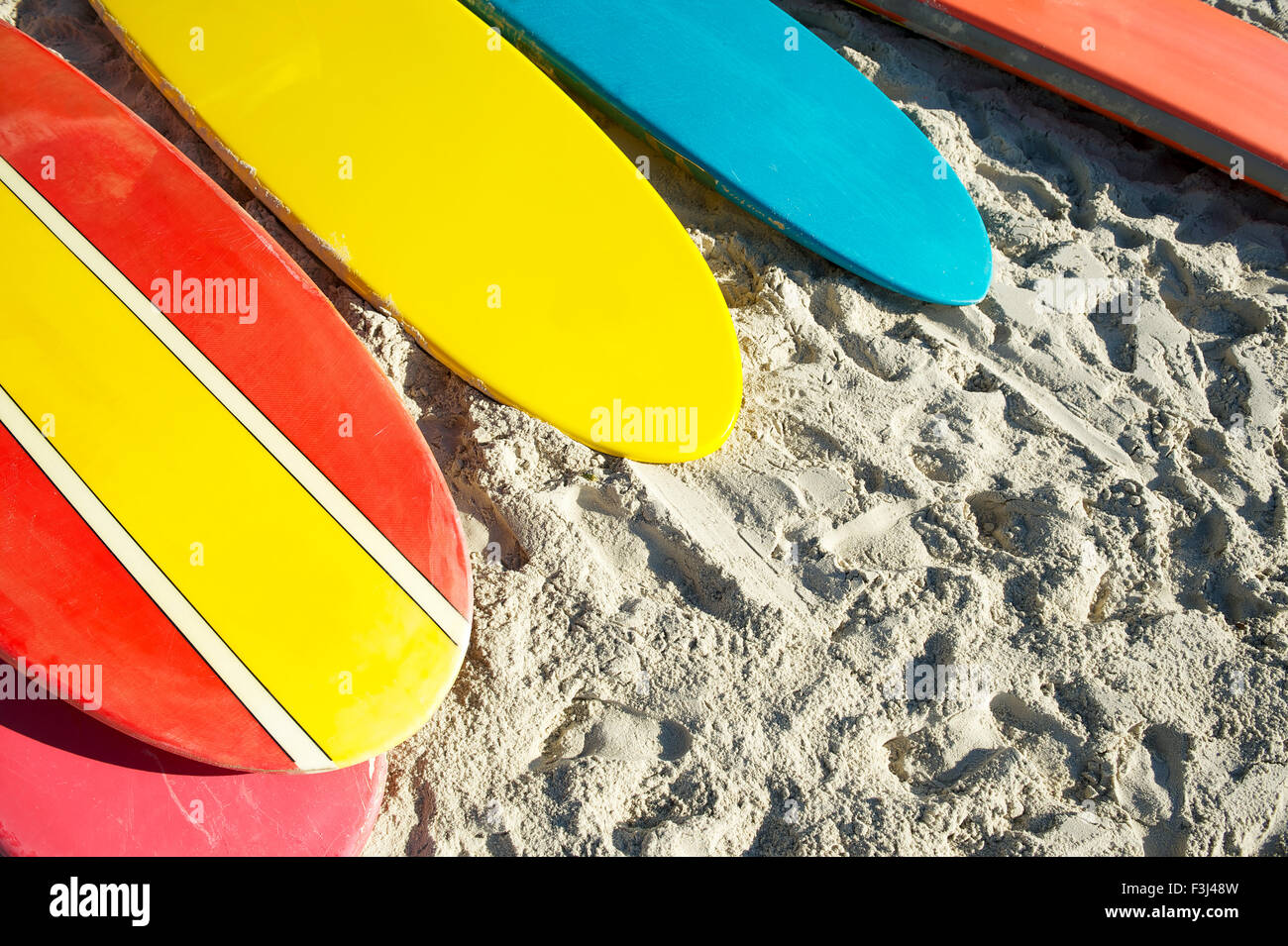 Stand up paddle long board surfboards in bright colors on Copacabana ...