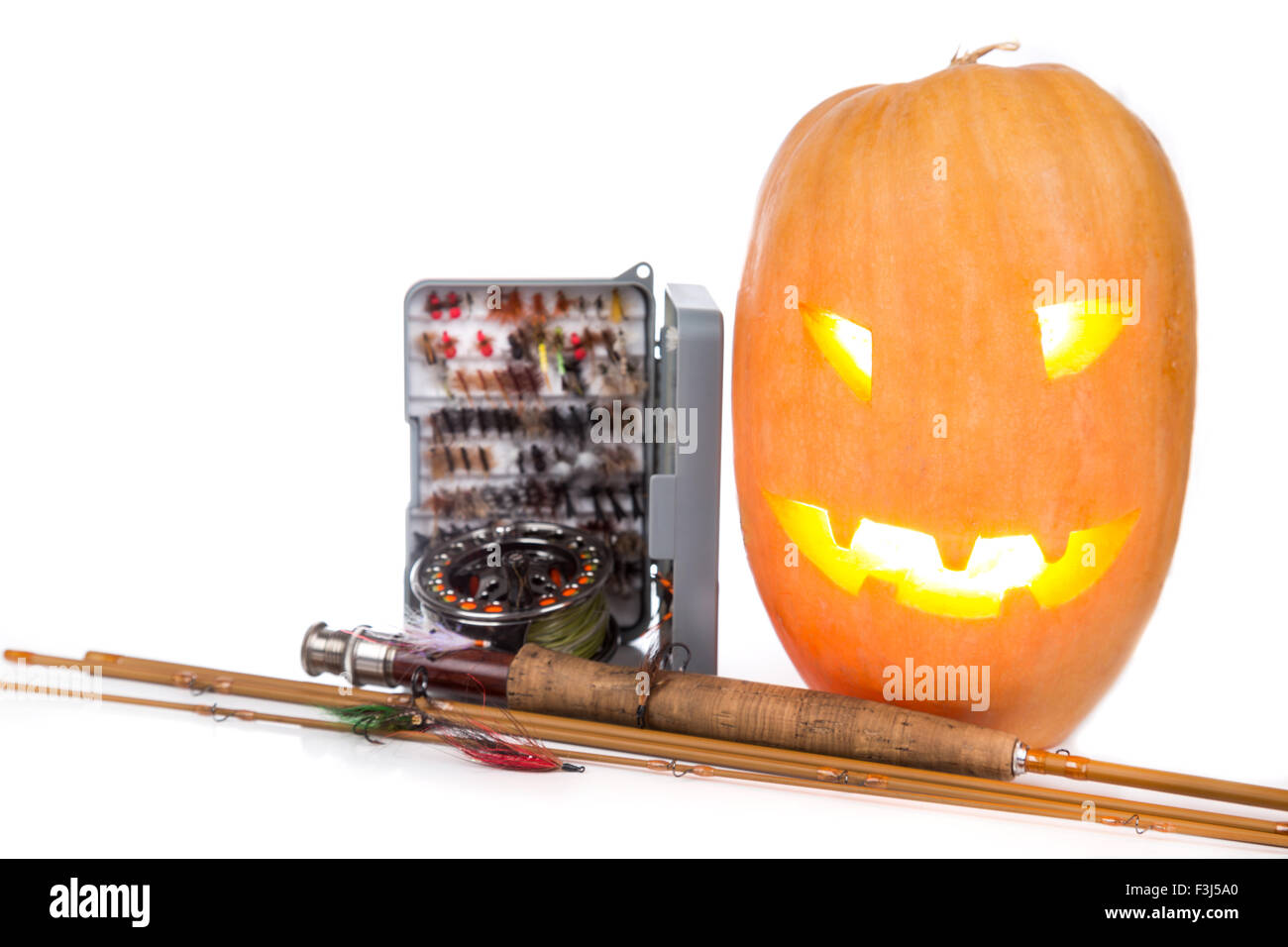 halloween pumpkin head with fly-fishing tackles on white background ...