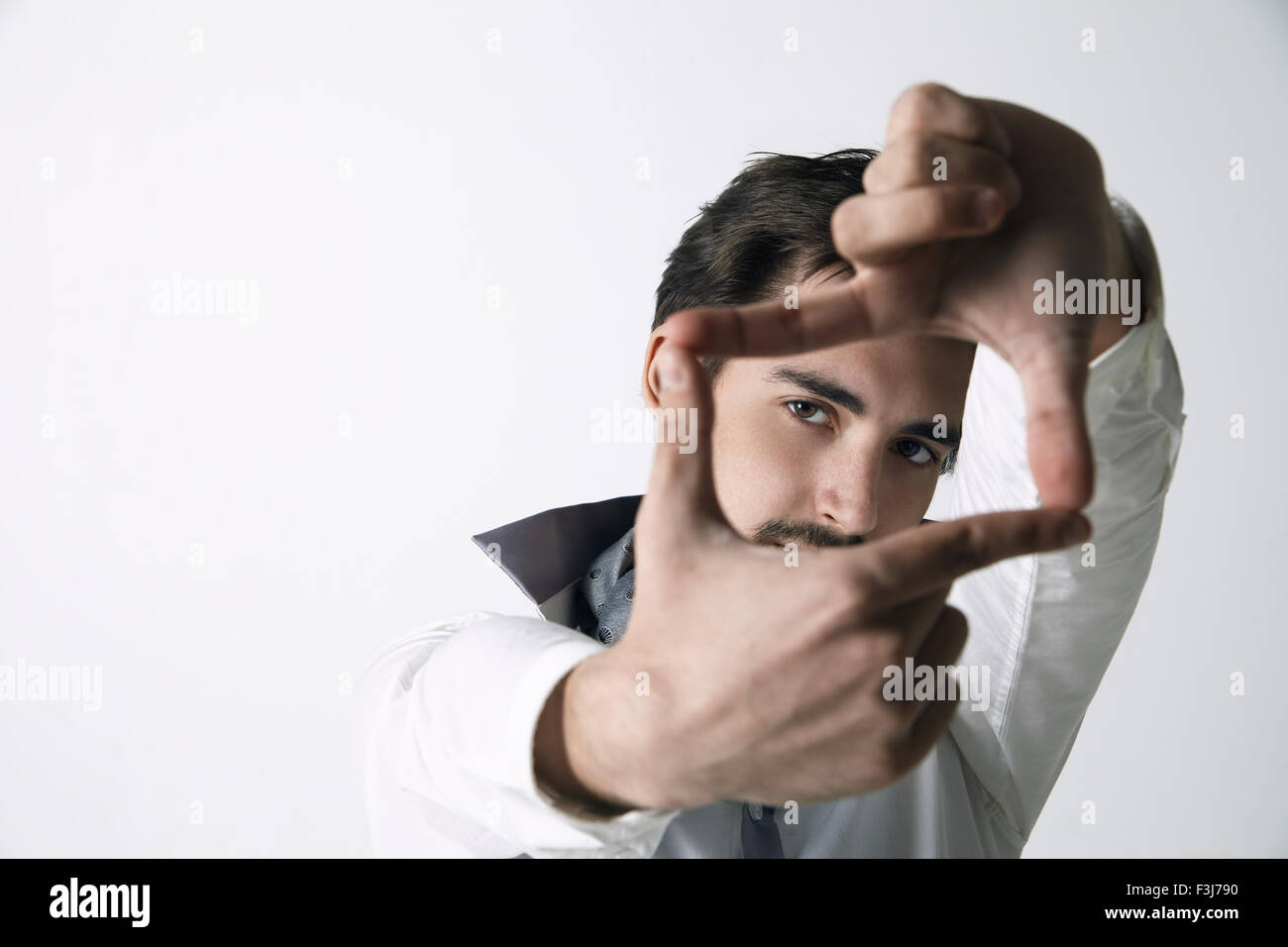 Closeup of young man framing photograph Stock Photo - Alamy