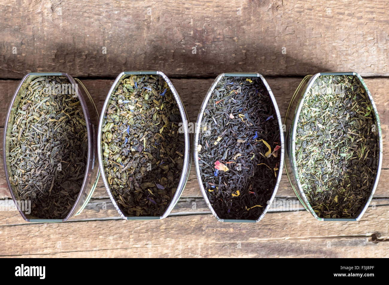 Collection assortment of dry tea in tin cans. Rustic style for ...