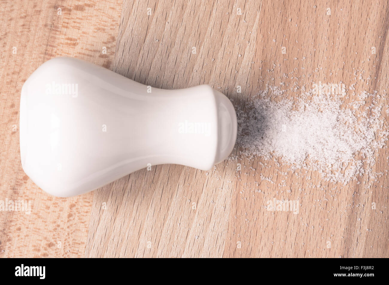 Salt shaker spill salt top view Stock Photo - Alamy