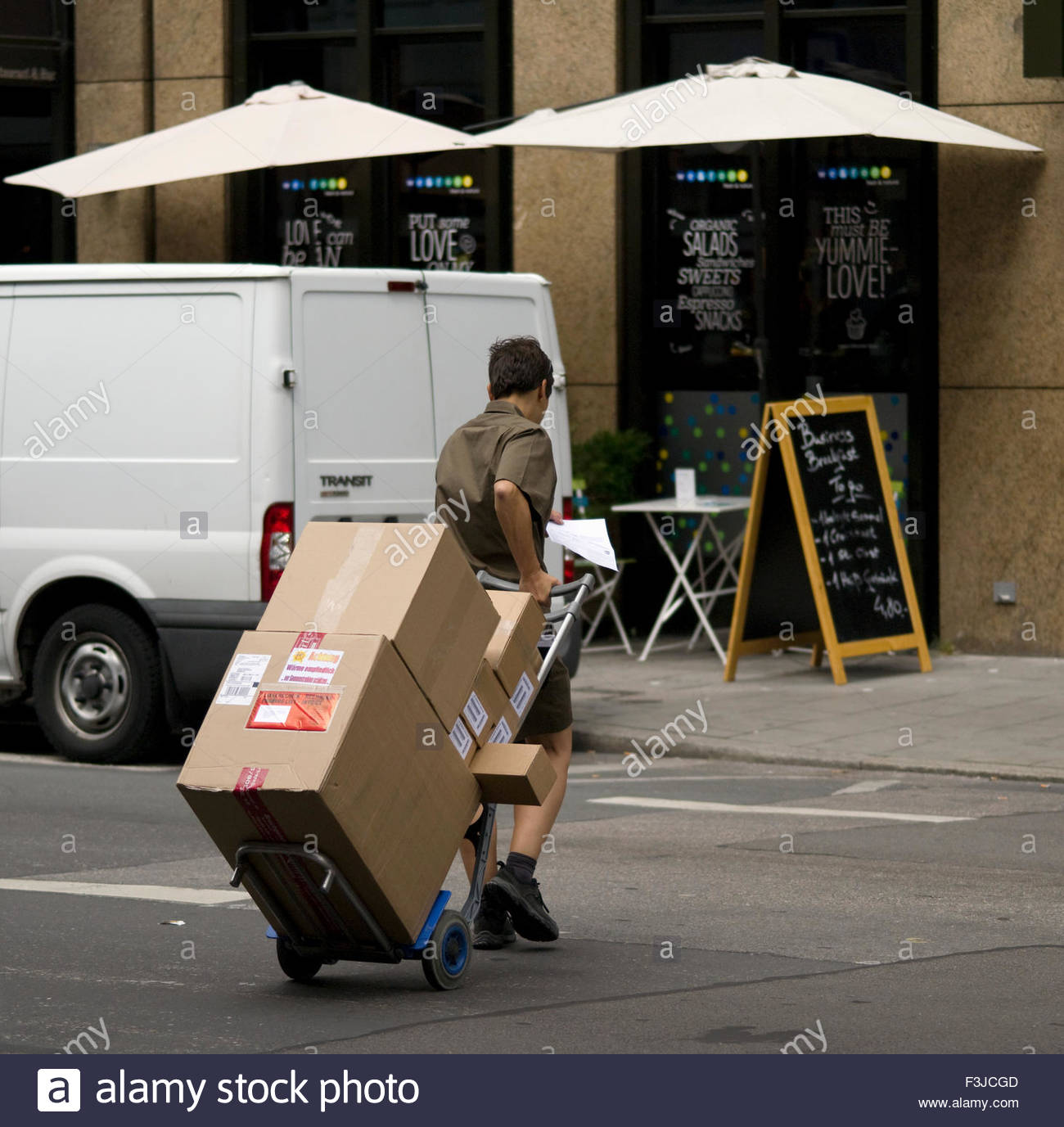Delivery Man Pushing Trolley Parcels Stock Photos & Delivery Man ...