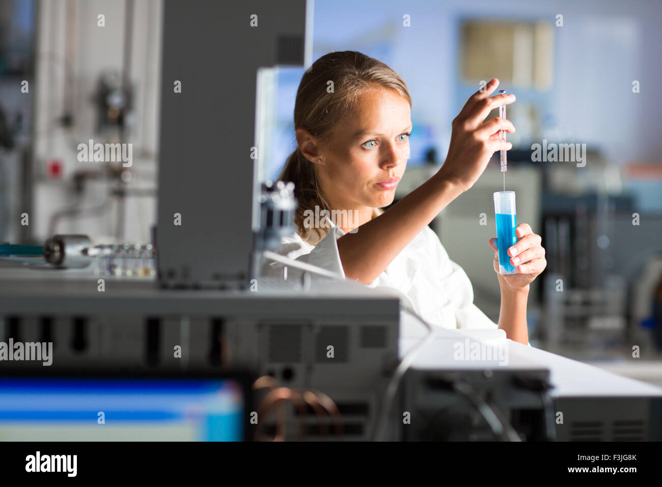 Portrait of a female researcher doing research in a lab (shallow DOF ...