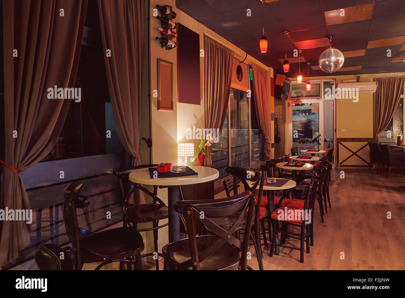 Interior of a modern cafe in retro style, night scene. Illumination ...