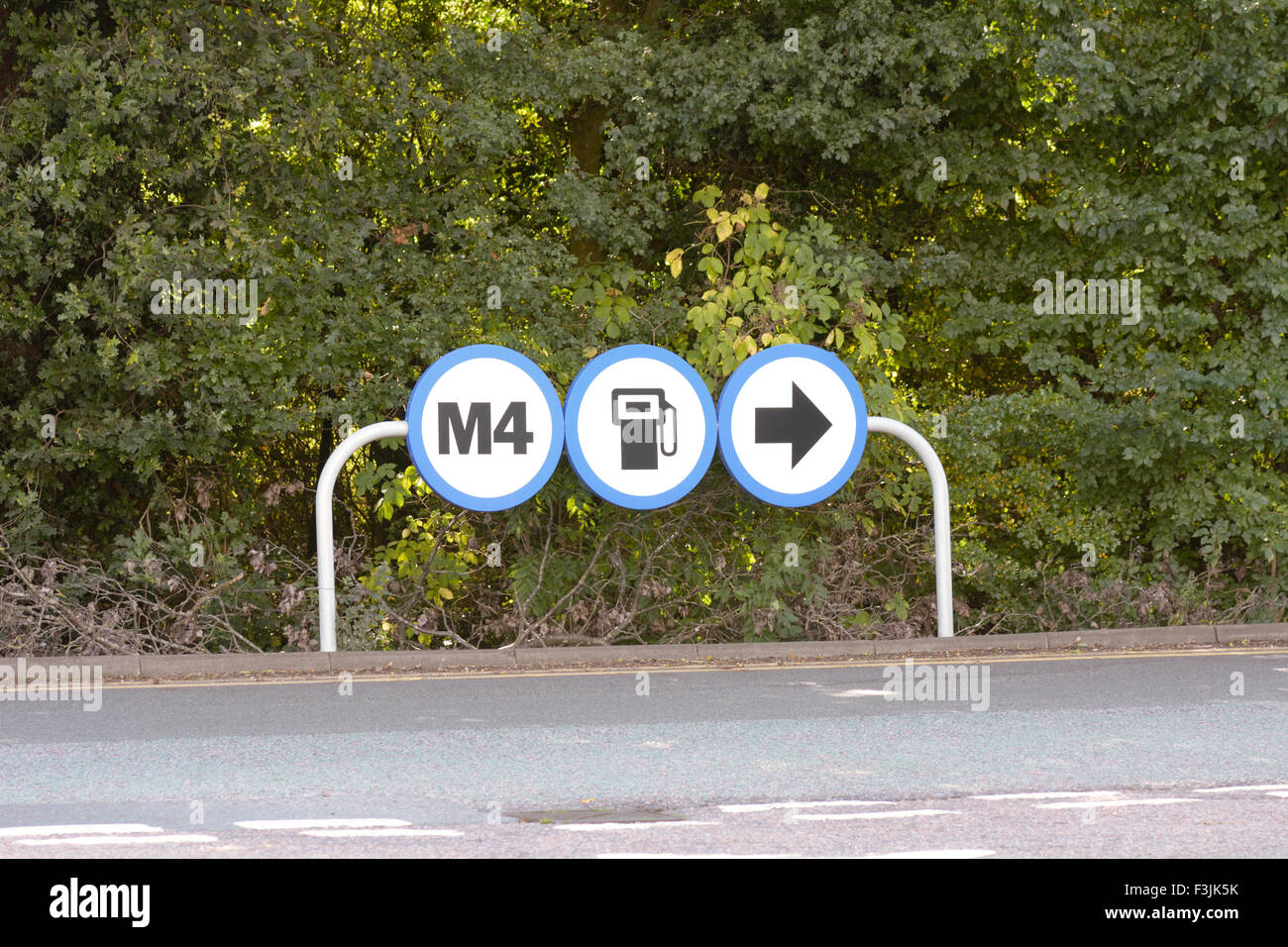 Signs in service station for M4 Motorway and fuel with direction arrow ...