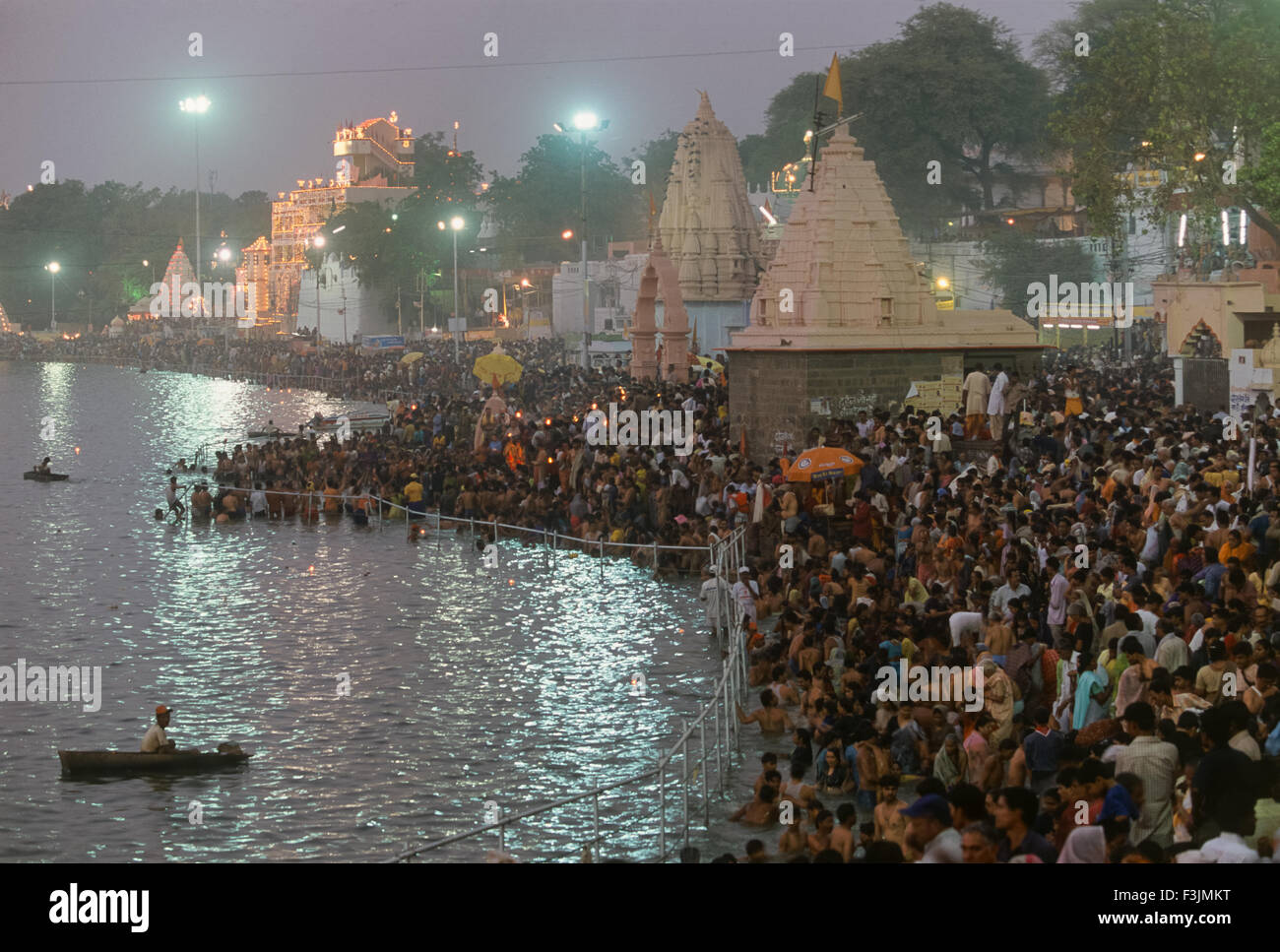 Bathing pilgrims thronging the ghats of the Shipra River during evening ...