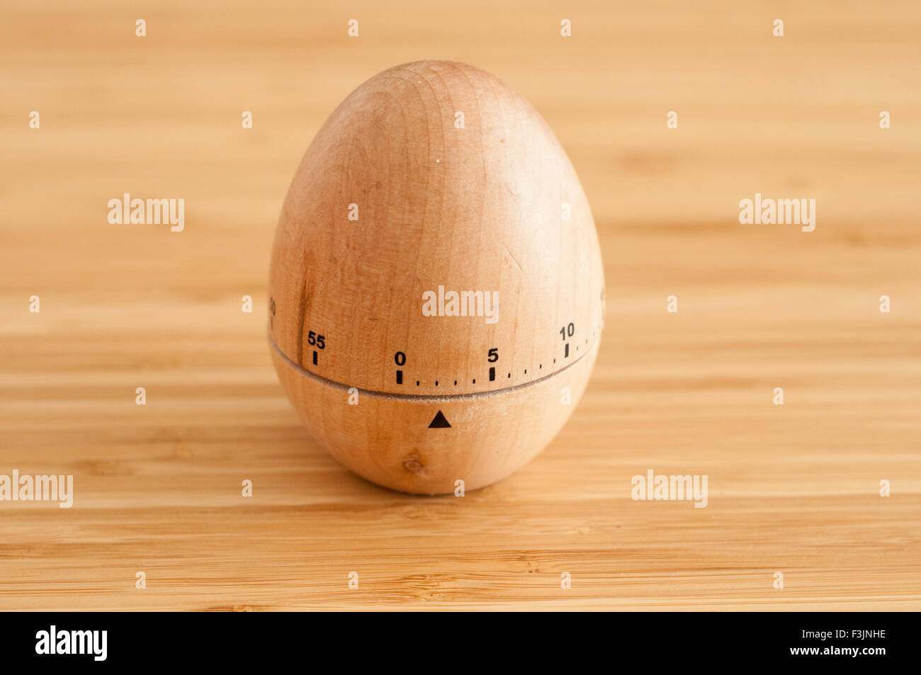 Egg timer on a wooden surface in natural light Stock Photo - Alamy