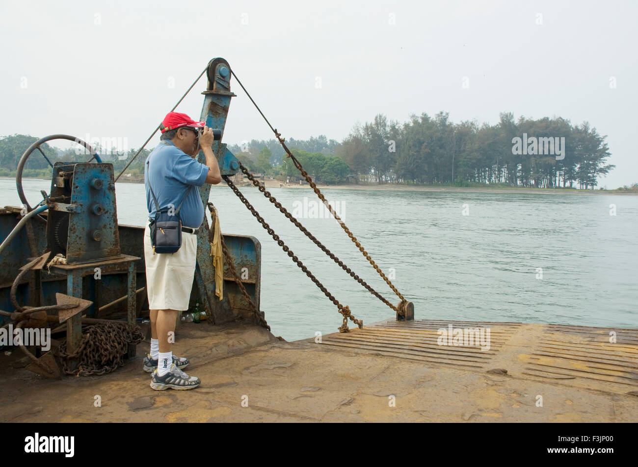 Tourist taking photographs from boat at Terekhol fort ; Vengurla ...