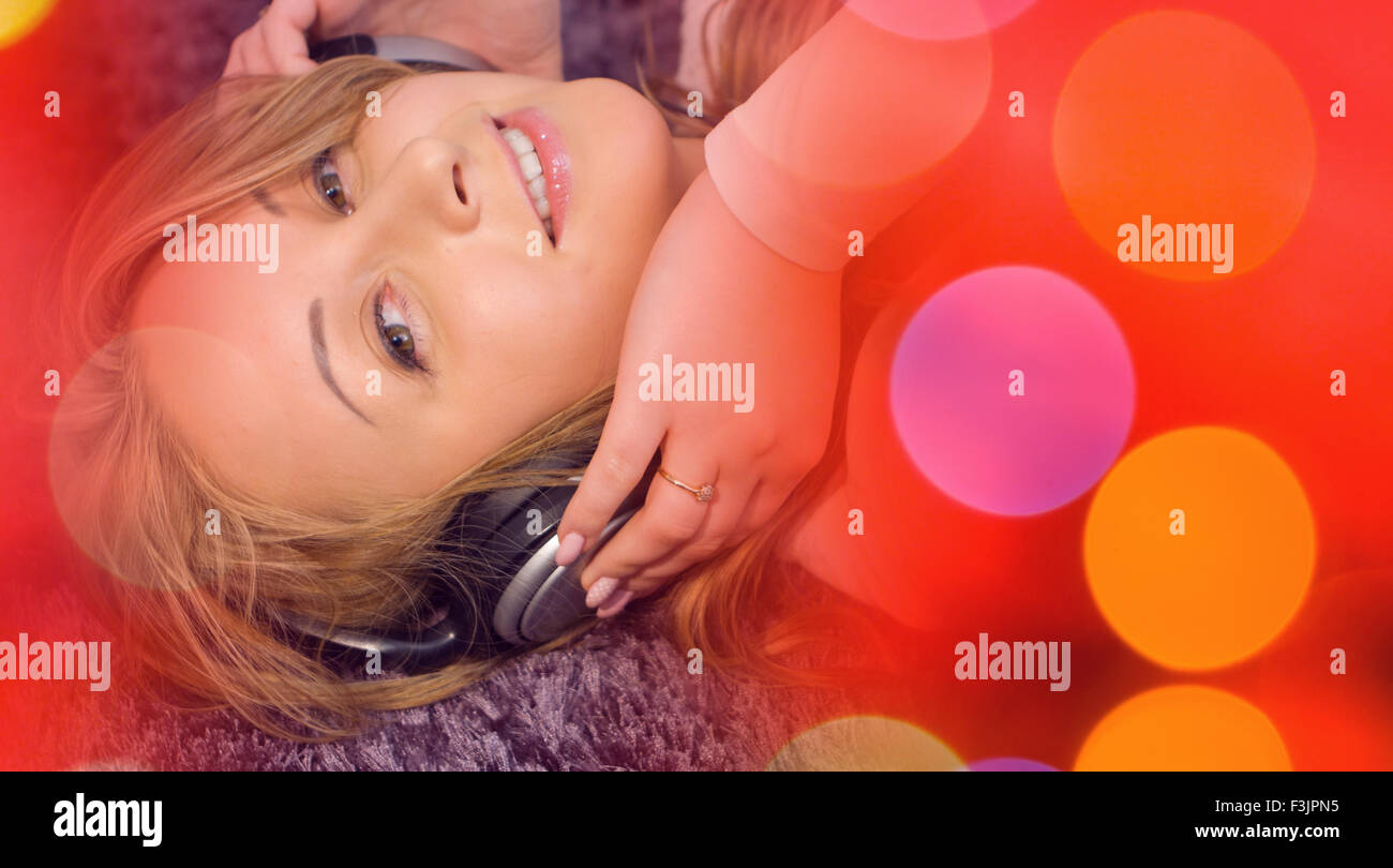 Pretty young woman in headphones listening music background Stock Photo ...