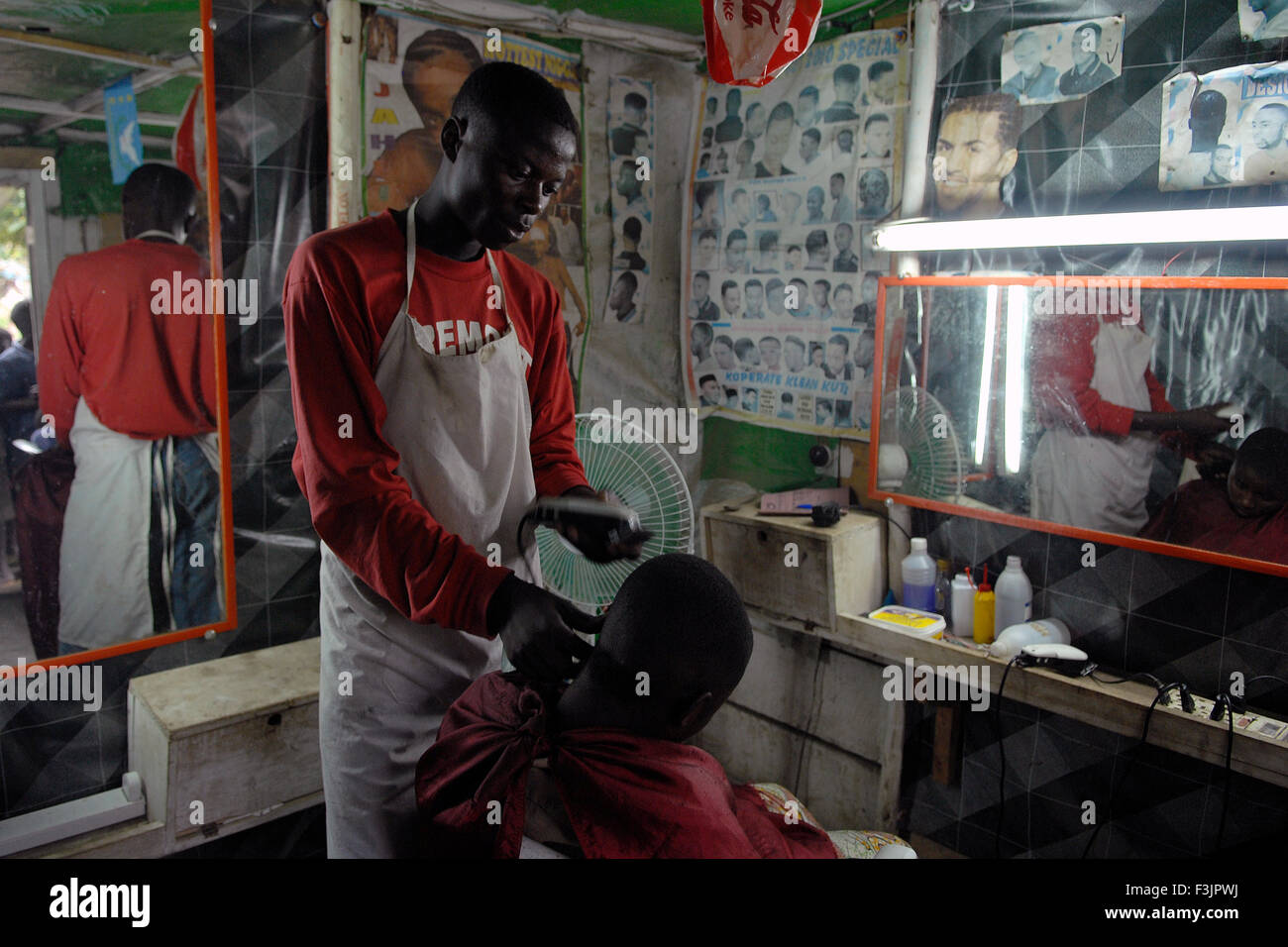A barber styling clients' hair in North Kivu province, DR Congo Africa ...