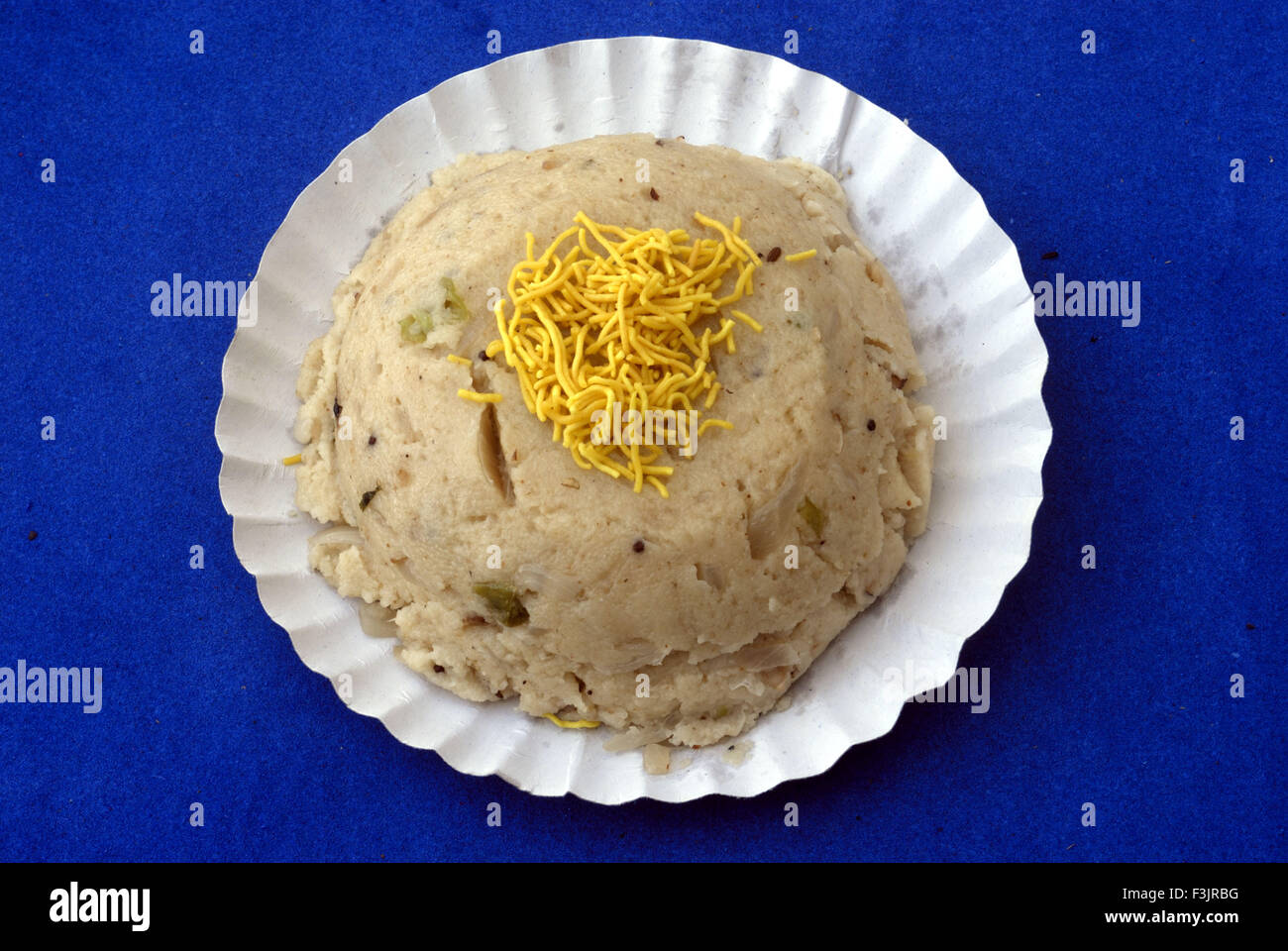 Upma breakfast in paper plate on blue background India asia Stock Photo ...