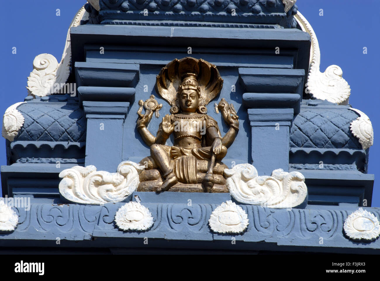 Lord Vishnu sitting on coiled serpent Shesha at decorated colorful ...