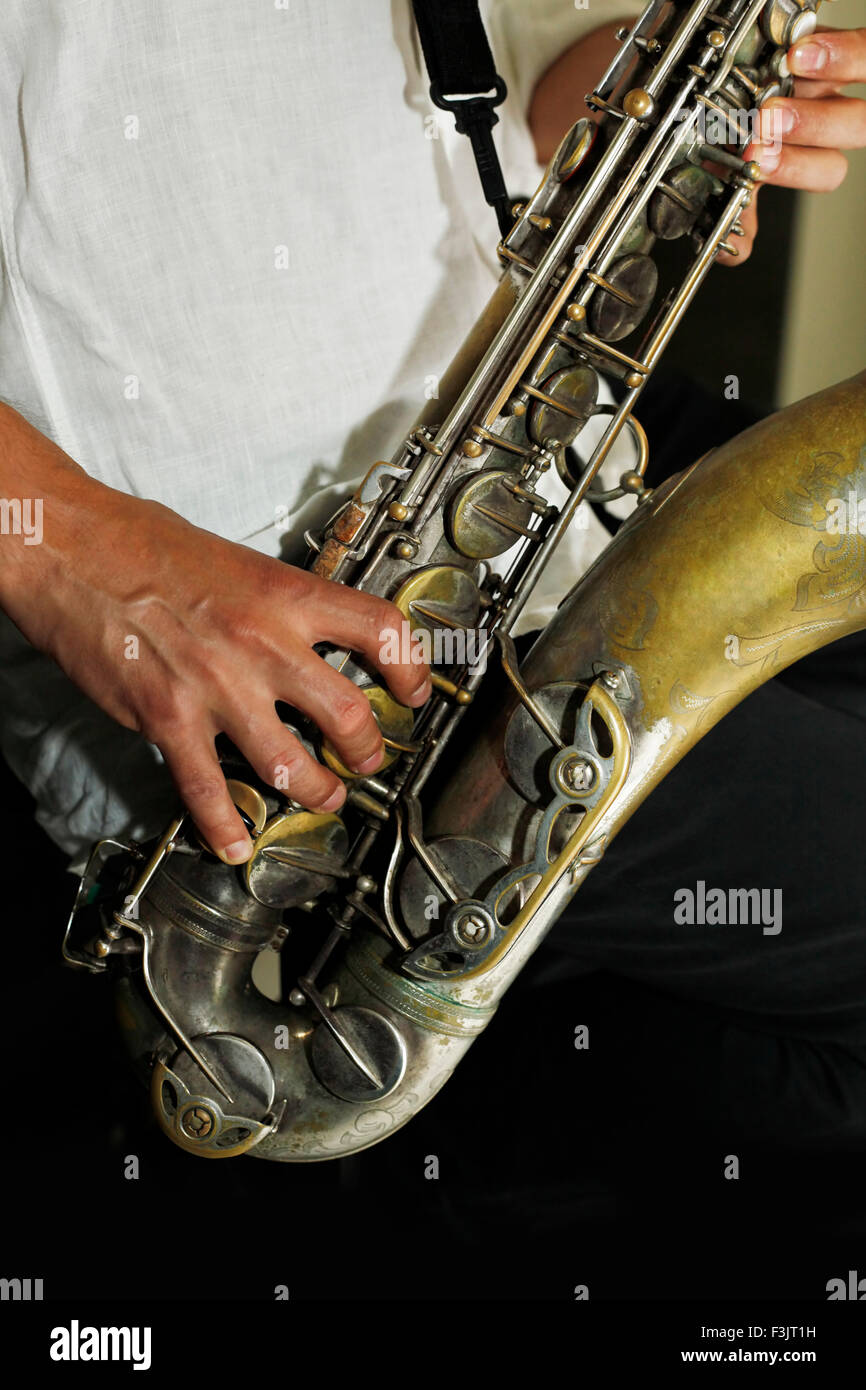 Hands of the saxophonist with a saxophone Stock Photo - Alamy