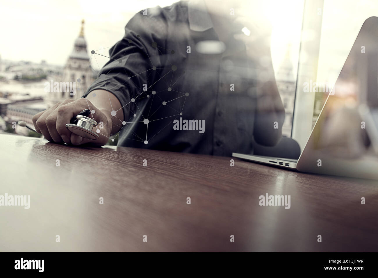 designer hand working and smart phone and laptop on wooden desk in ...